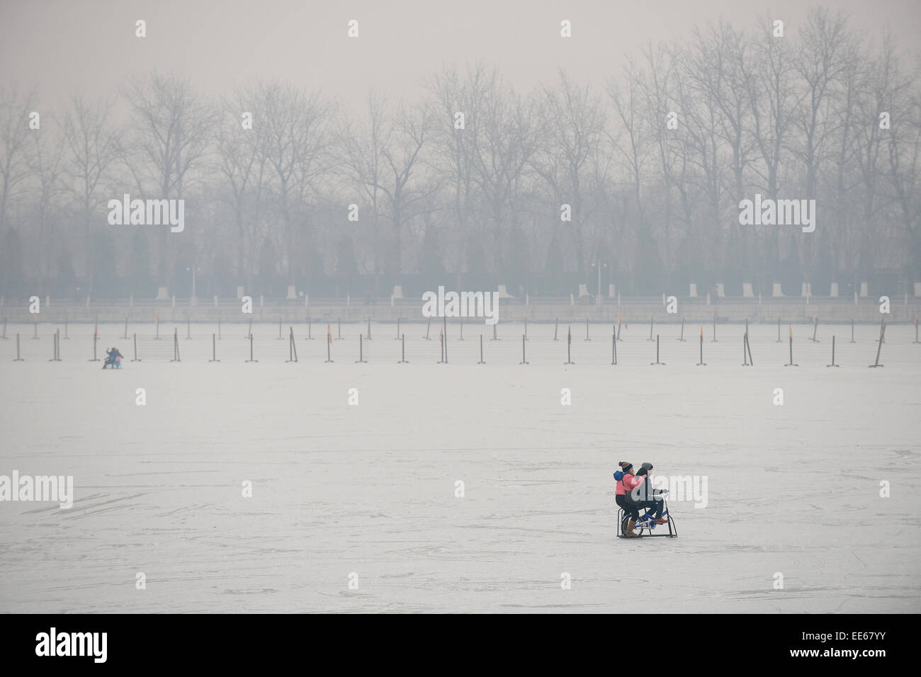 Beijing, China. 14th Jan, 2015. Tourists play a sledge on the frozen ...