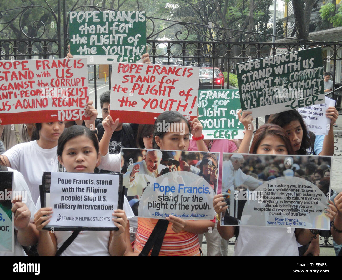 Activists display placards and postcards of Pope Francis in front of ...