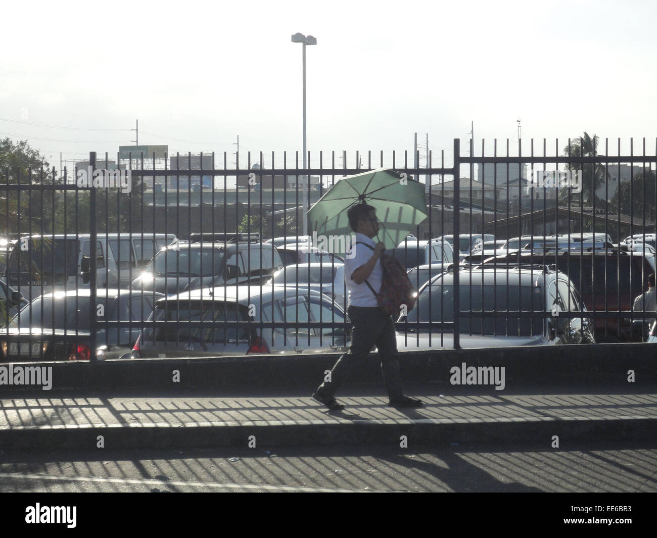A Filipino student walks to a tricycle terminal outside a membership ...