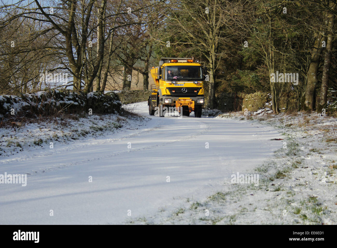 Gritter at work on a snow covered road Stock Photo - Alamy
