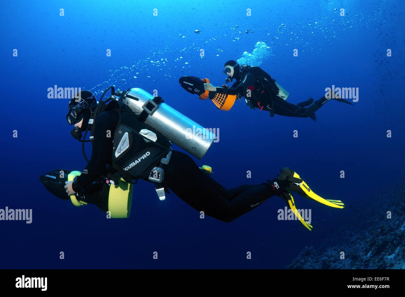 Two divers swim to an underwater scooter, Red Sea, Egypt Stock Photo ...