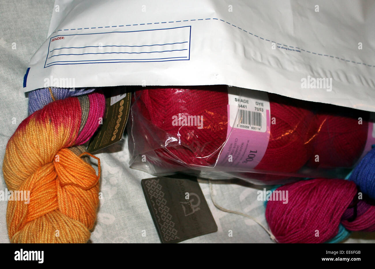 Yarn spills from a parcel. The yarn is of various types, from Acrylic ...
