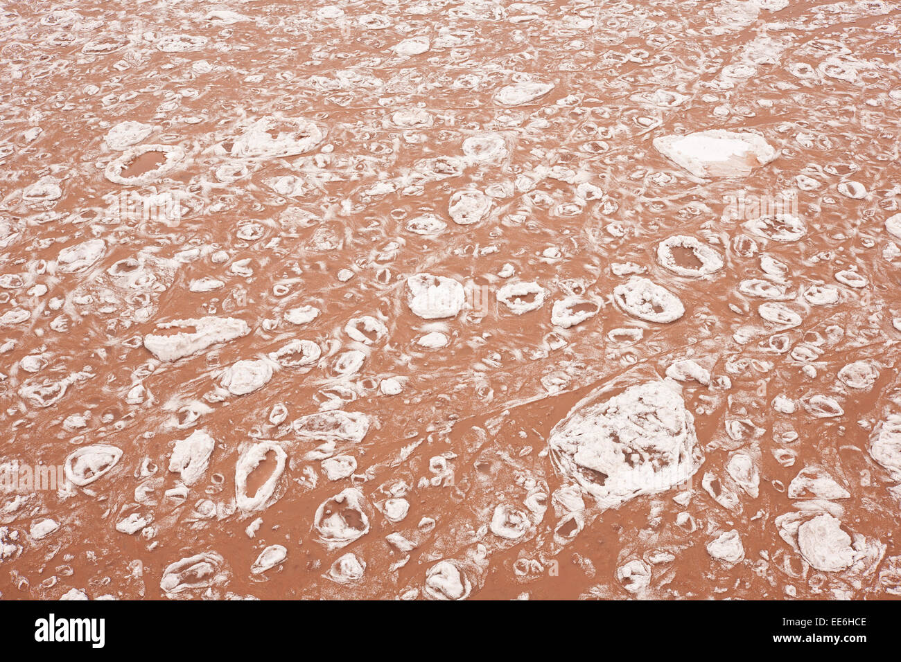 Ice flow in muddy river Stock Photo - Alamy