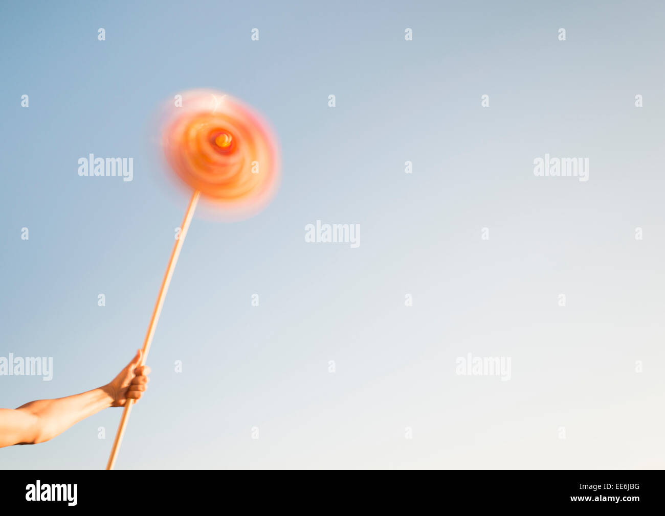Hand holding pinwheel toy spinning in the wind. Conceptual image of ...