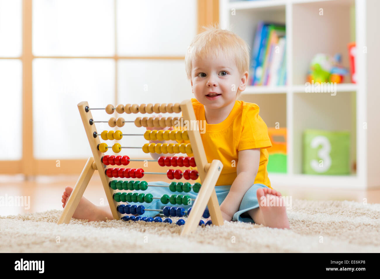 child boy playing with counter Stock Photo - Alamy
