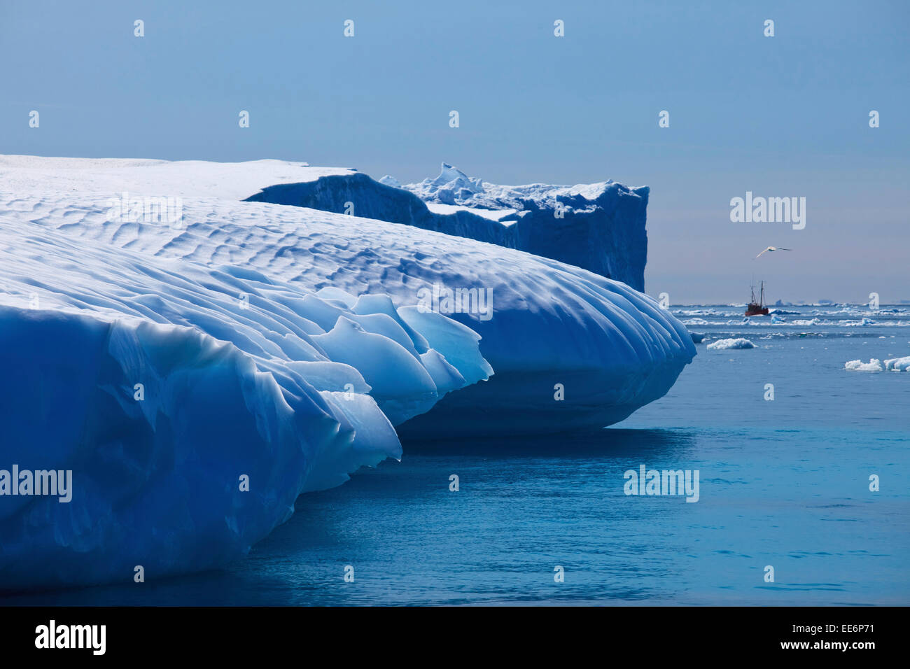 Fishing boat and iceberg, Arctic Ocean, Greenland Stock Photo - Alamy