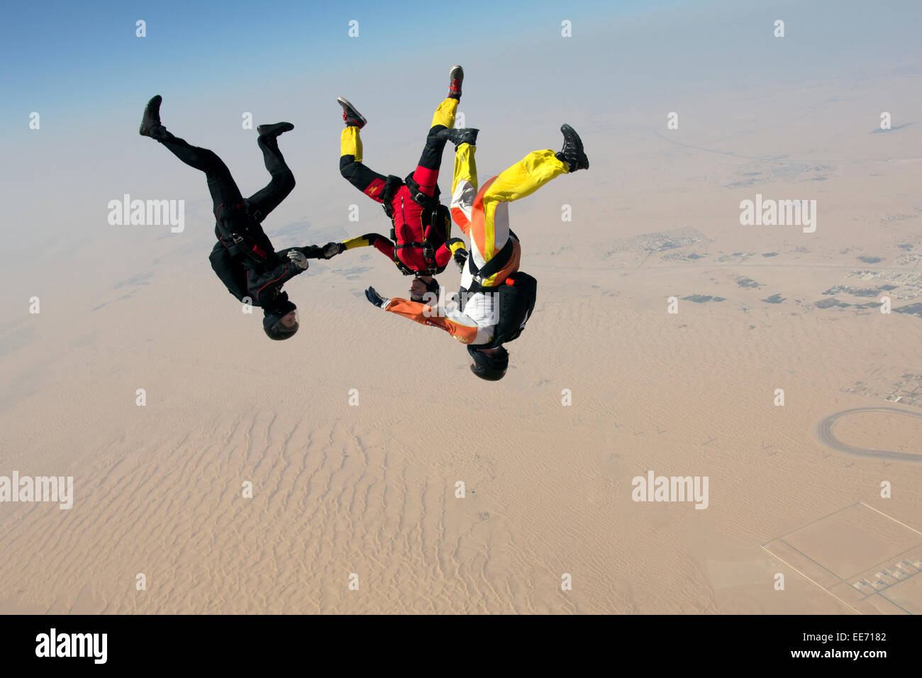 Skydiving freefly team is holding hand in freefall with 120mph speed ...