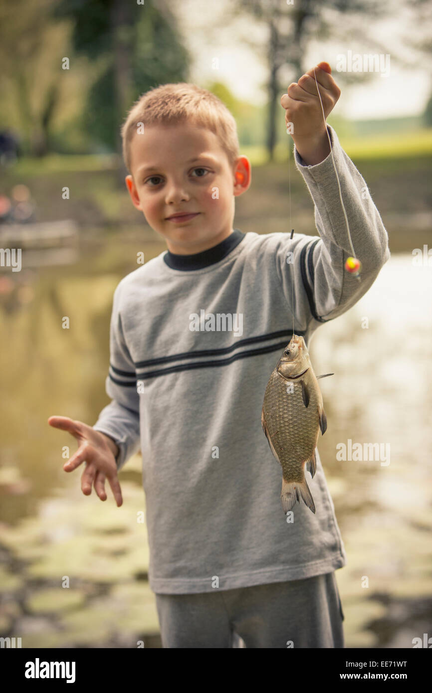 Boy with fresh caught fish Stock Photo - Alamy