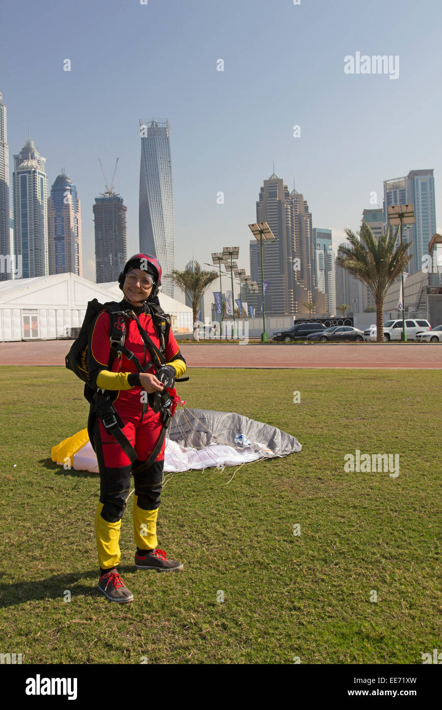 Skydiving girl landed save on the grass area in front of the Dubai sky ...