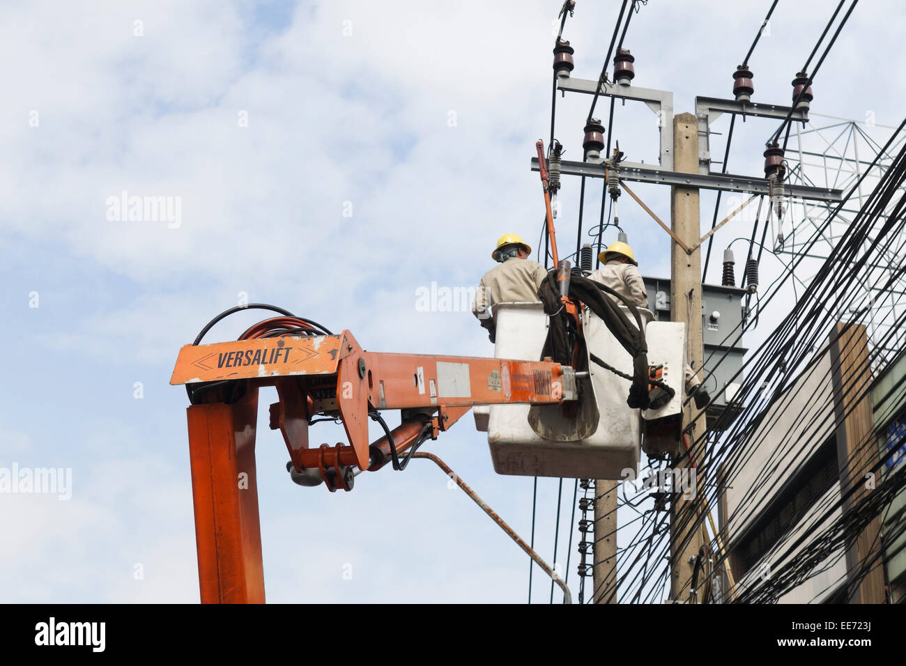 Workers at Electrical pole with crane, Cable clutter, Bangkok, Thailand ...