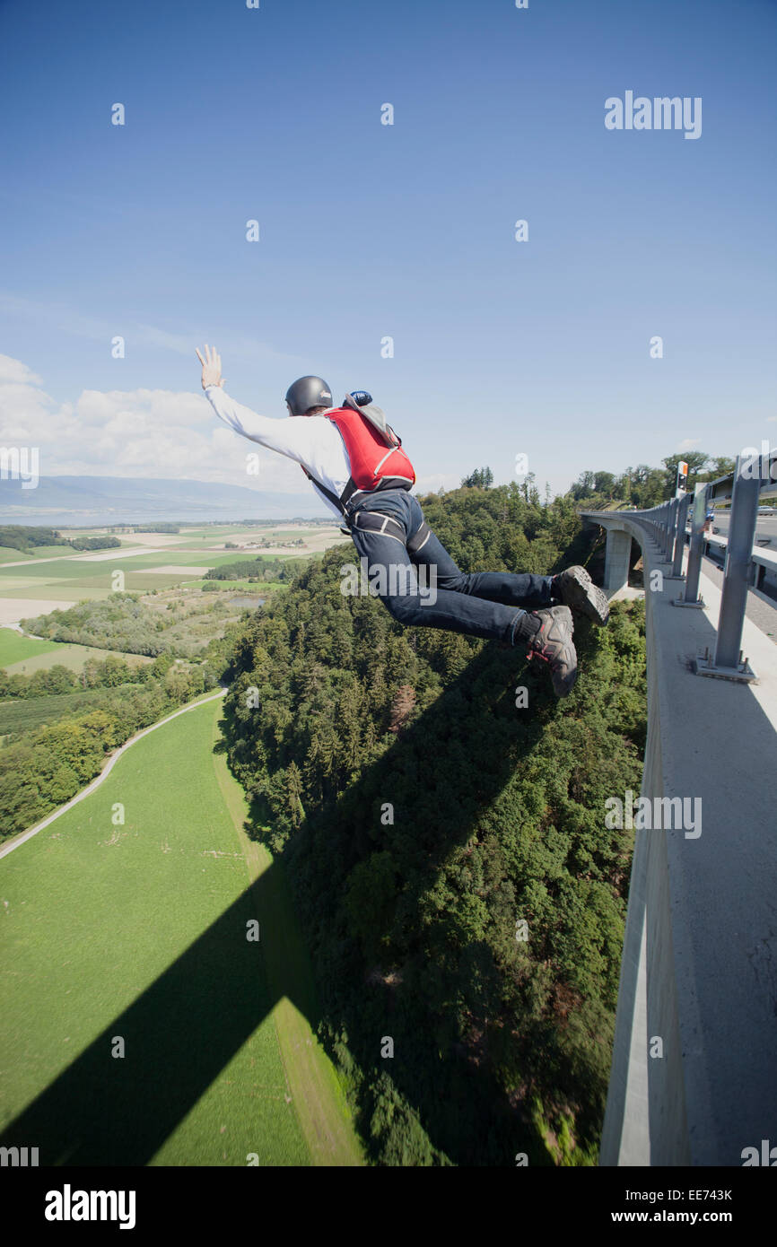 BASE jumper launched from a bridge. He will open his parachute in a ...