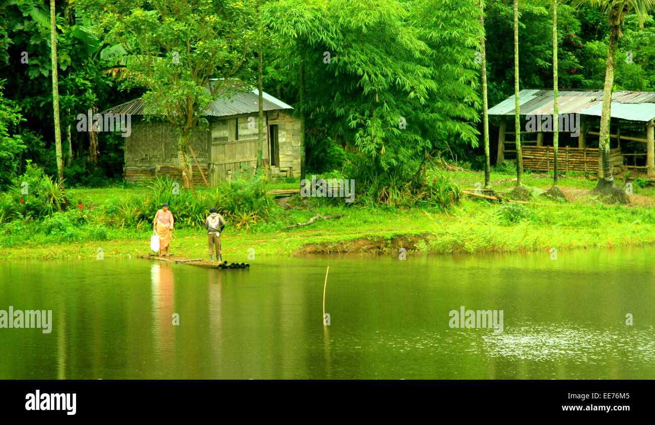 old couple using bamboo raft for cross the lake Stock Photo - Alamy