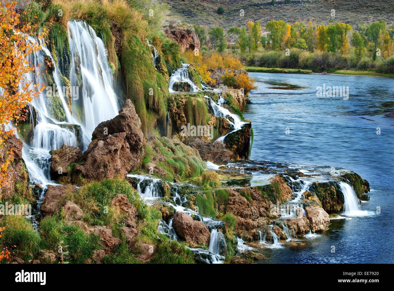 Detail of autumn waterfall with orange leaves Stock Photo - Alamy