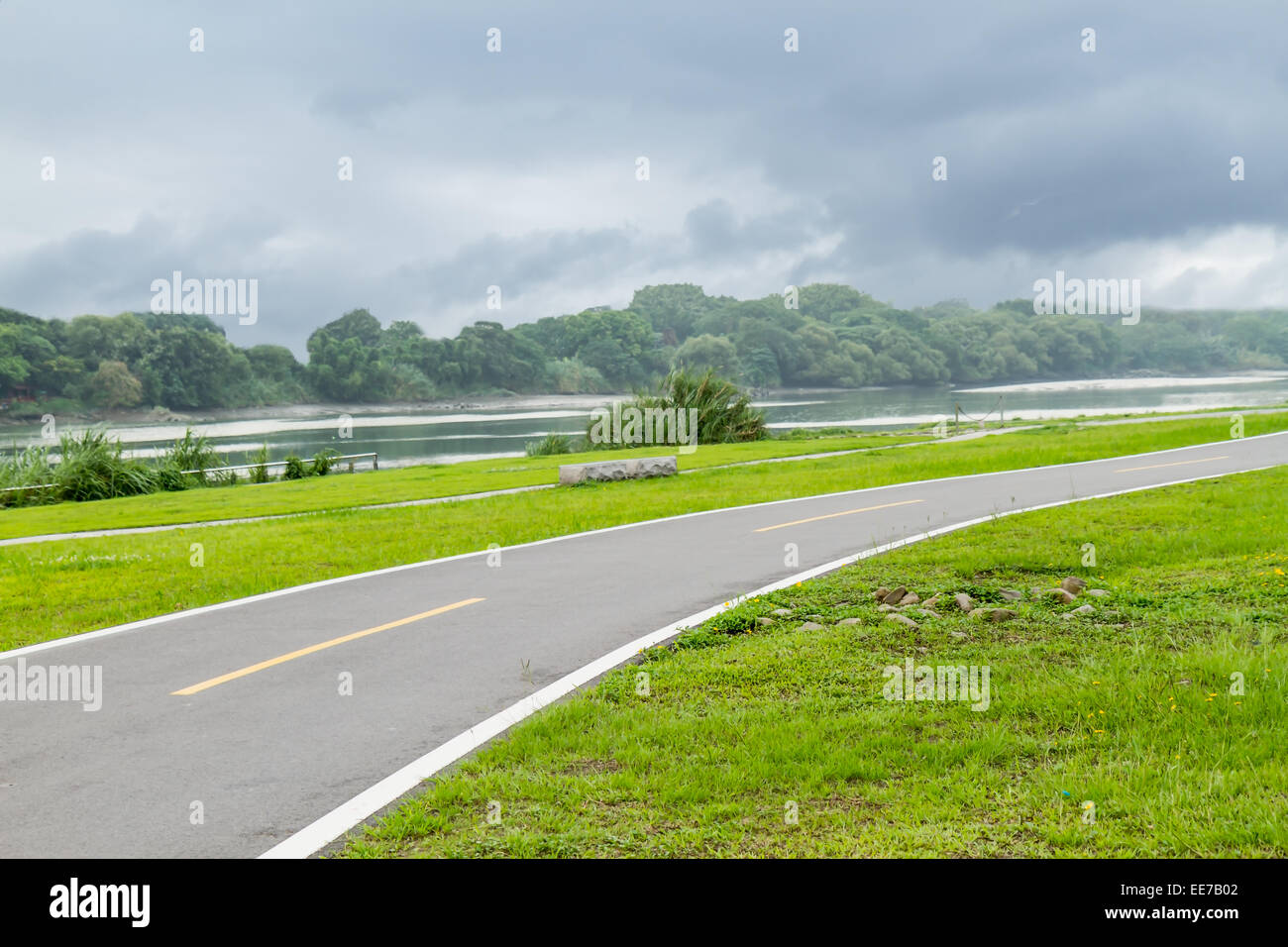 Cycling and jogging path by riverside recreational area Stock Photo - Alamy