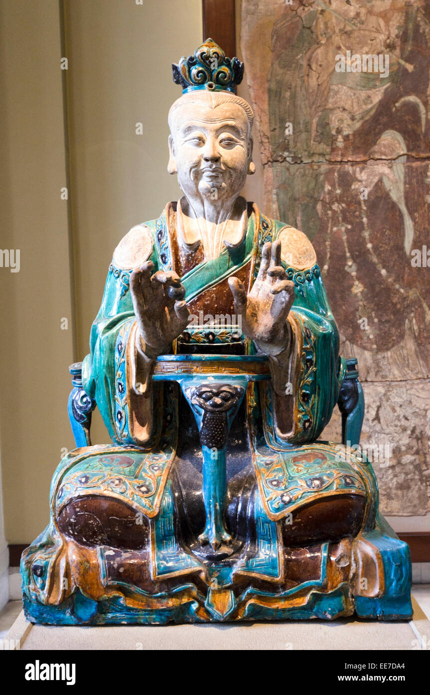 Stoneware figure of a Daoist deity with green, turquoise, purple and ...