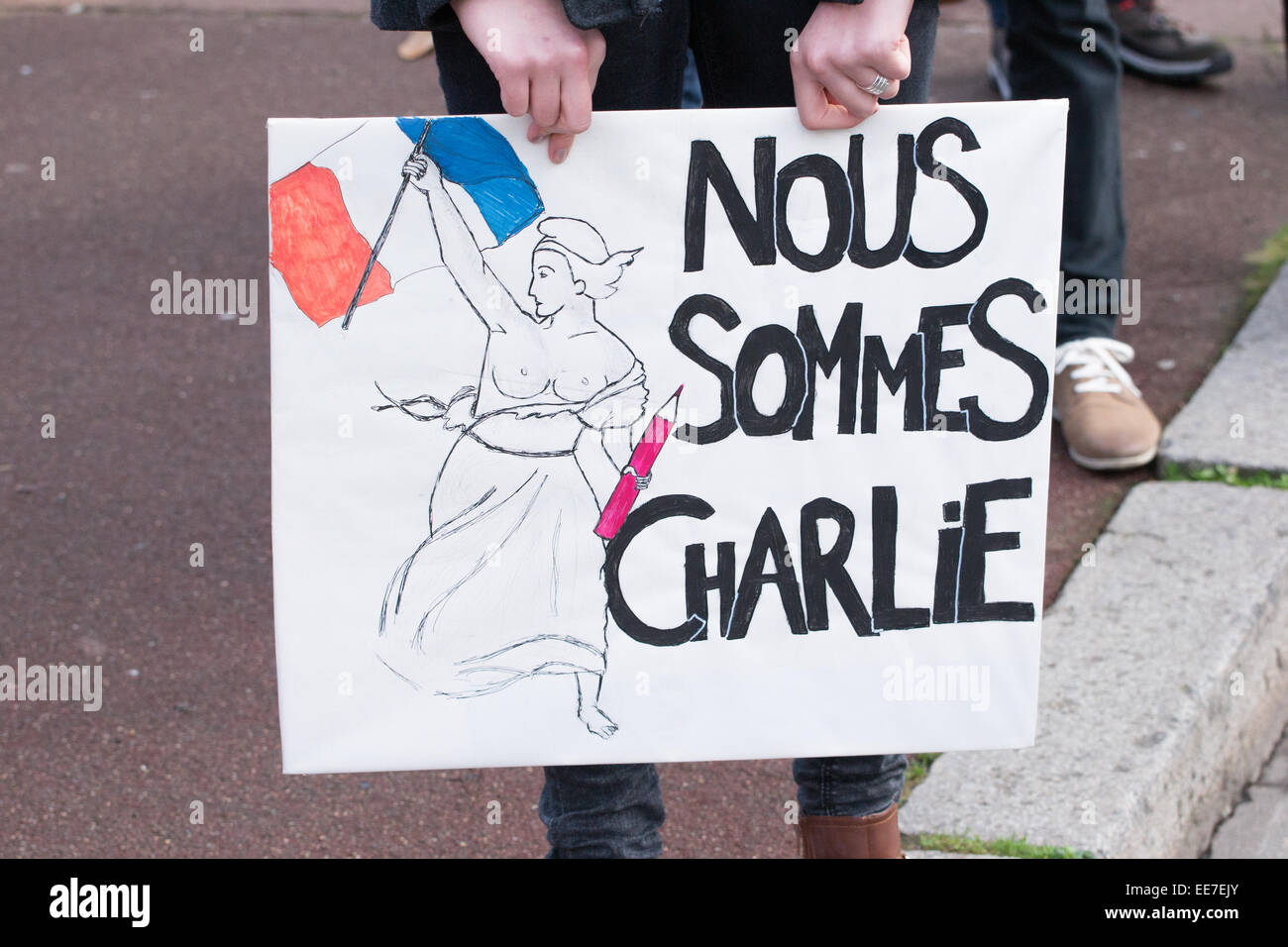 A young woman with a slogan "We are Charlie" during gathering "Je Suis ...