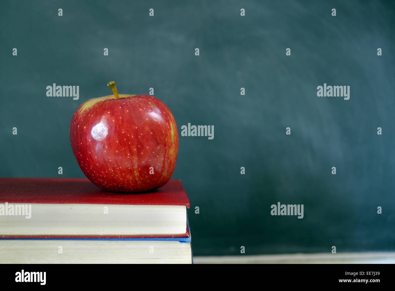 red apple on books in classroom Stock Photo - Alamy