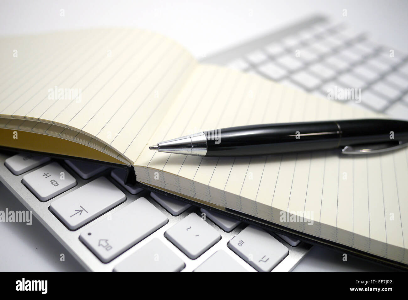 lined notebook on computer keyboard Stock Photo - Alamy