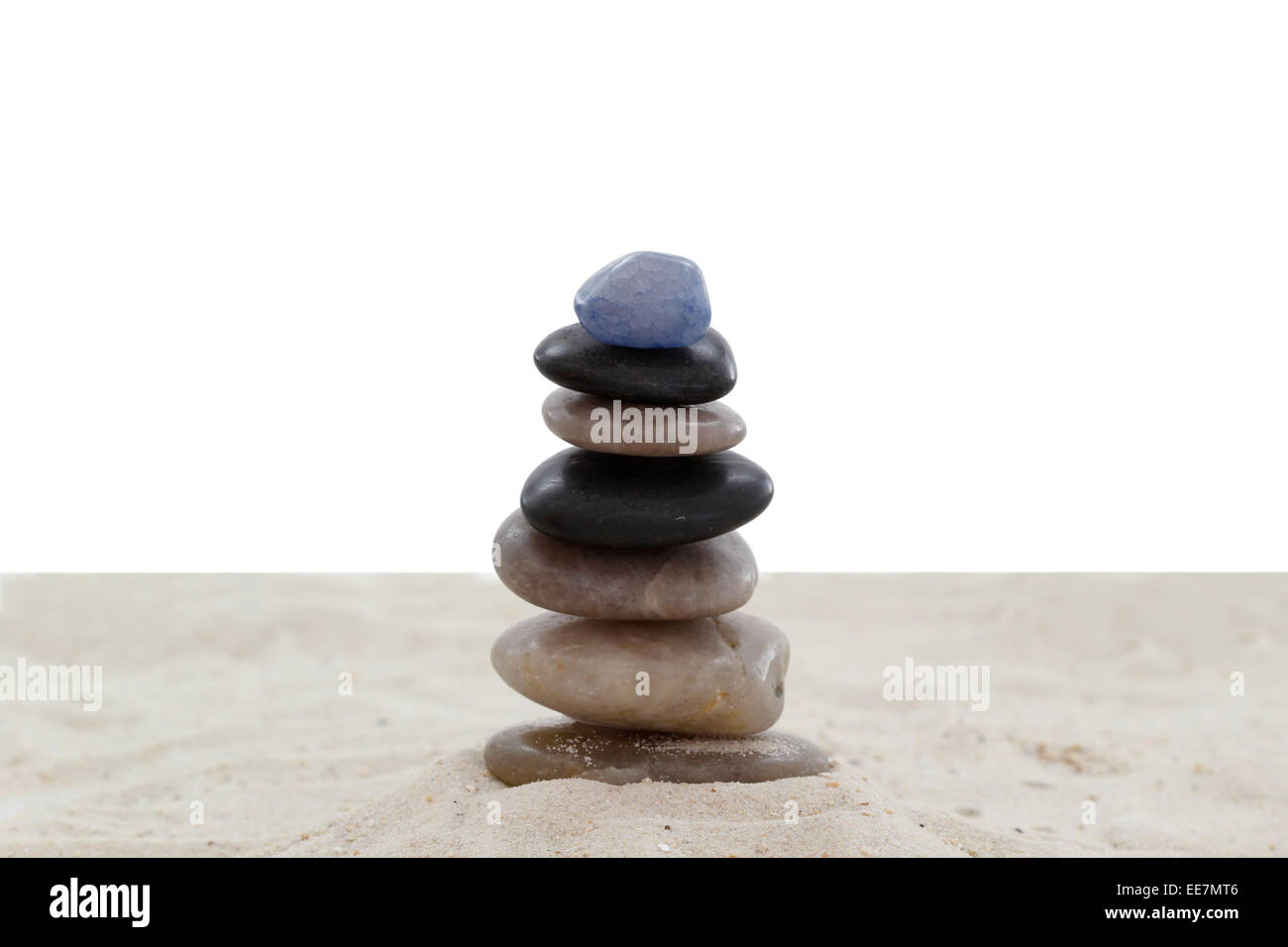 Pile of pebbles on sand over white background Stock Photo - Alamy