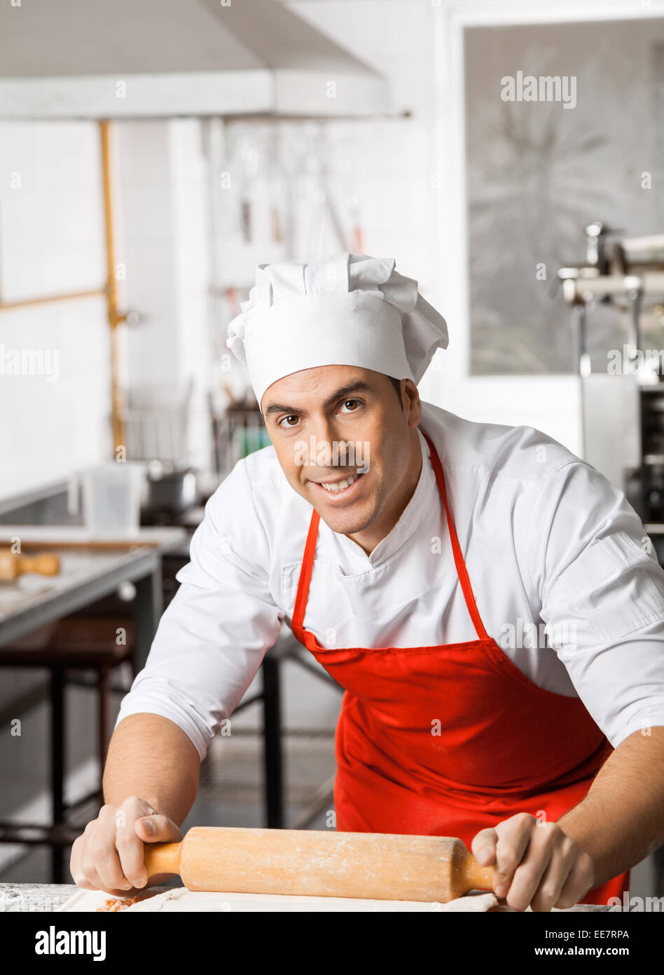 Smiling Male Chef Rolling Pasta Sheet At Counter Stock Photo - Alamy