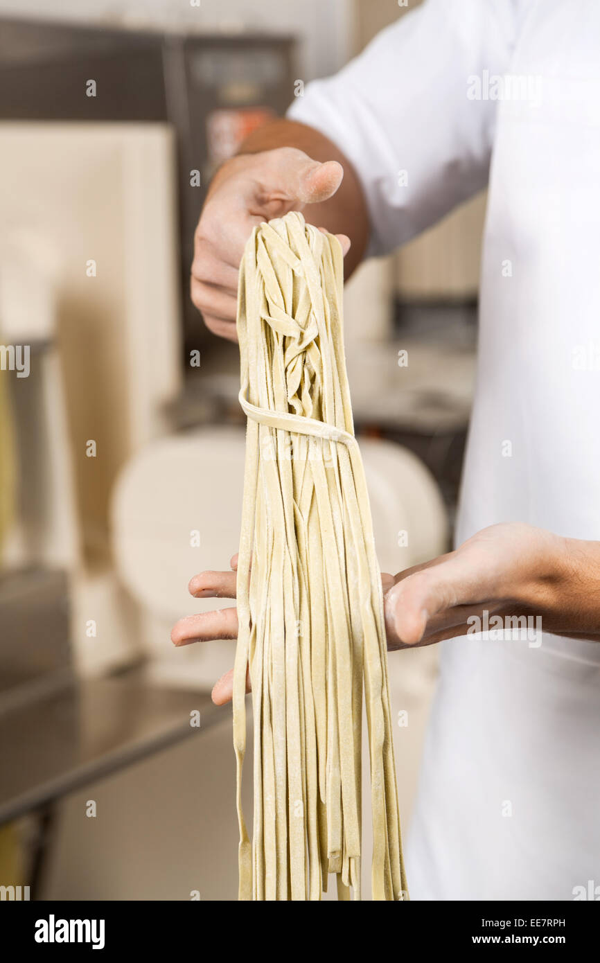 Chef Holding Spaghetti Pasta At Kitchen Stock Photo - Alamy