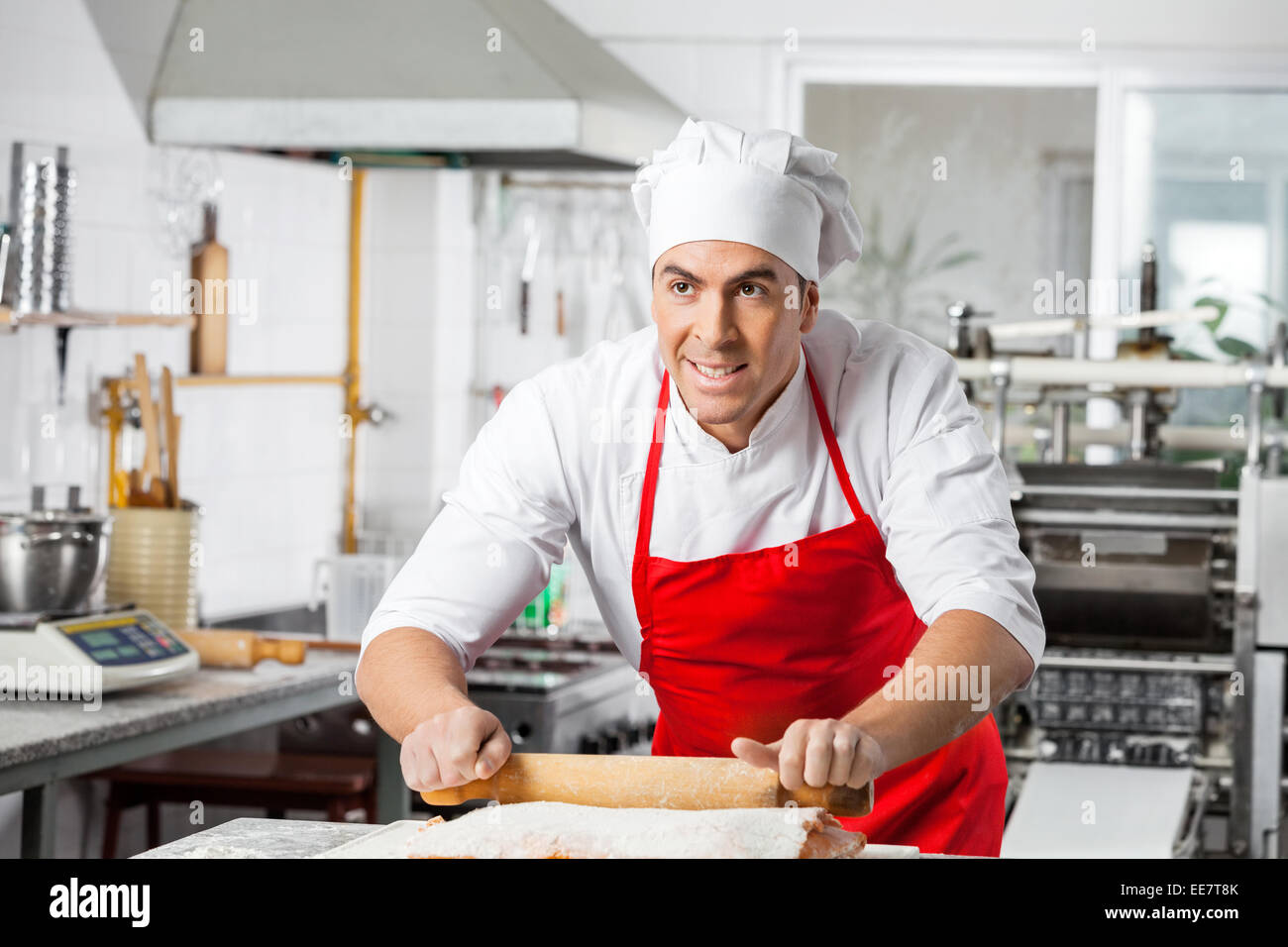 Chef Looking Away While Rolling Pasta Sheet At Counter Stock Photo - Alamy