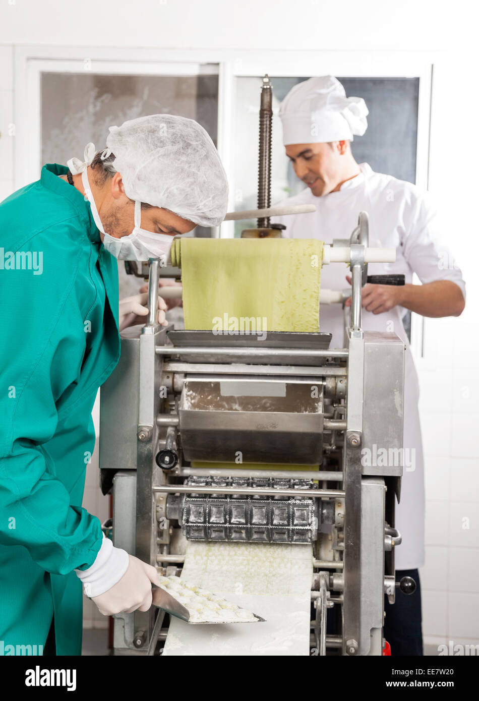 Chefs Processing Ravioli Pasta In Machine Stock Photo - Alamy