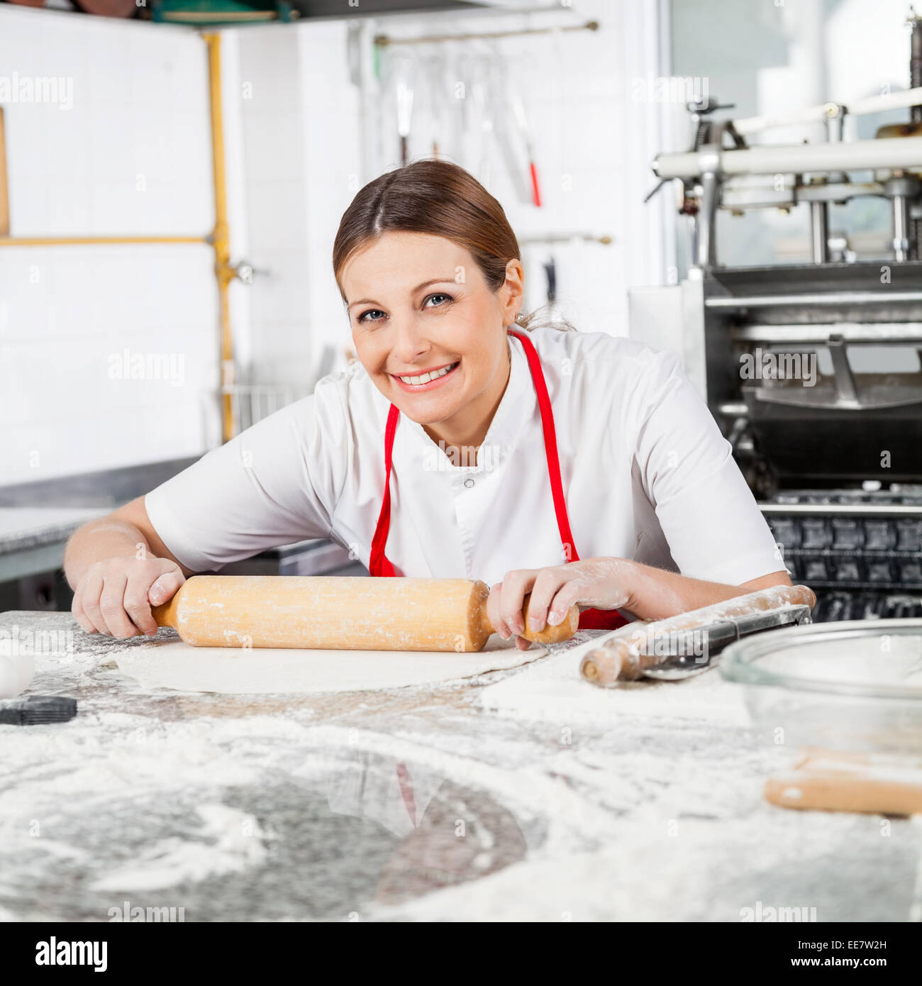 Happy Female Chef Rolling Pasta Sheet At Counter Stock Photo - Alamy