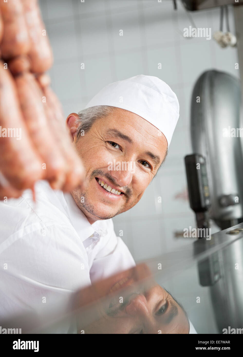 Butcher Smiling In Butchery Stock Photo - Alamy