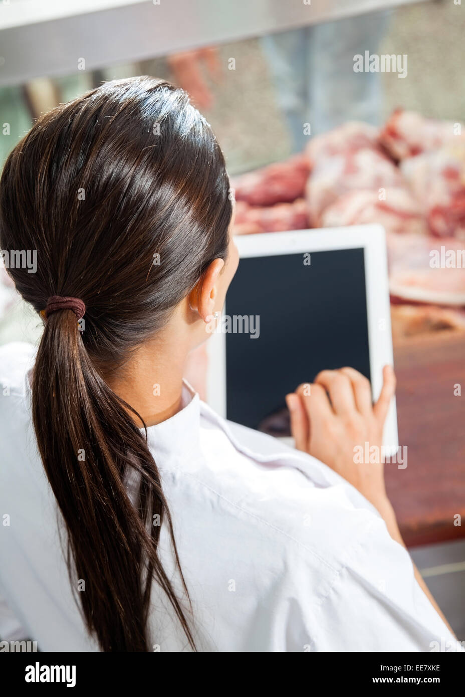 Butcher Using Digital Tablet In Store Stock Photo - Alamy
