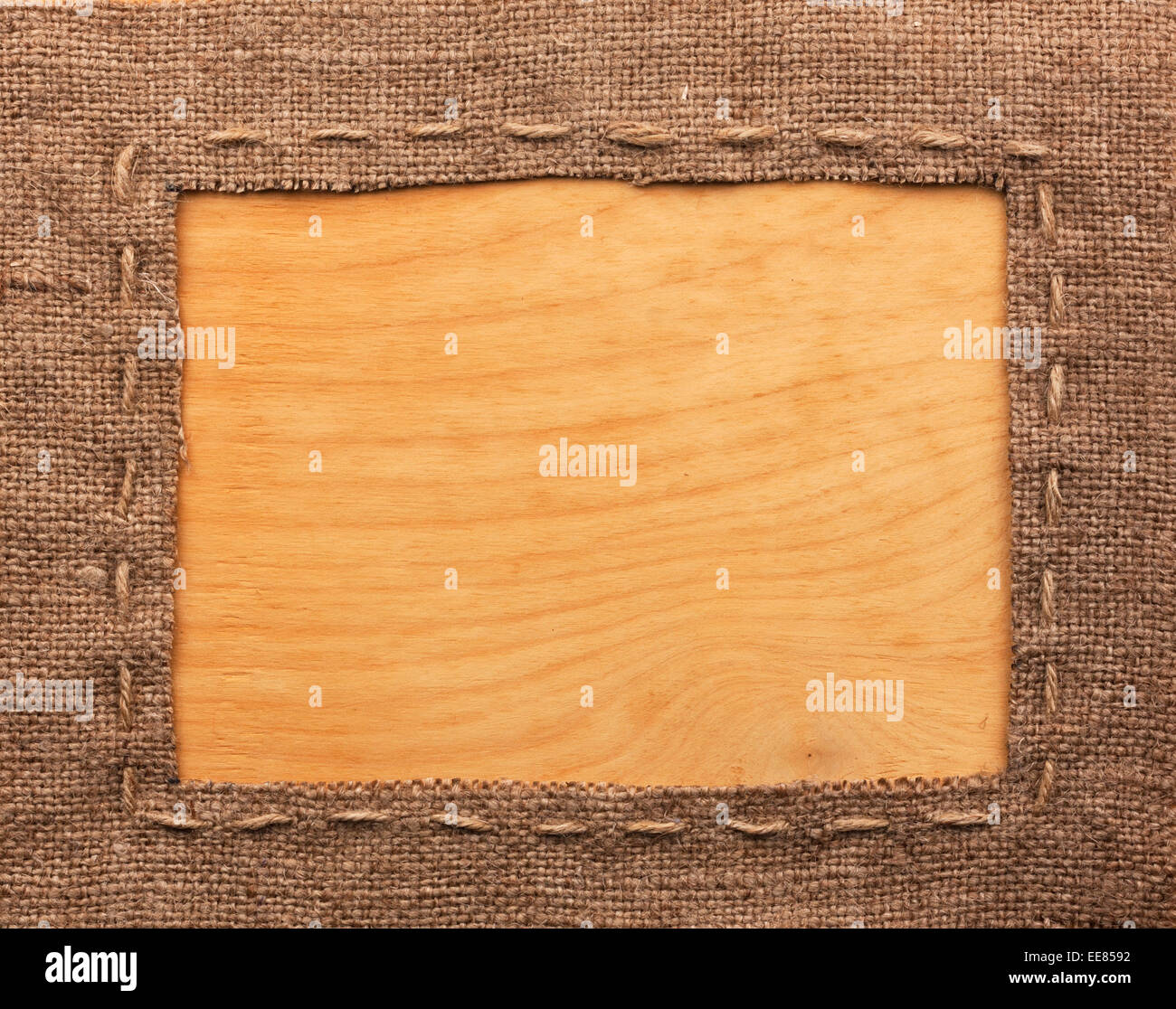 Frame of burlap, lies on a background of wood, with place for your text ...