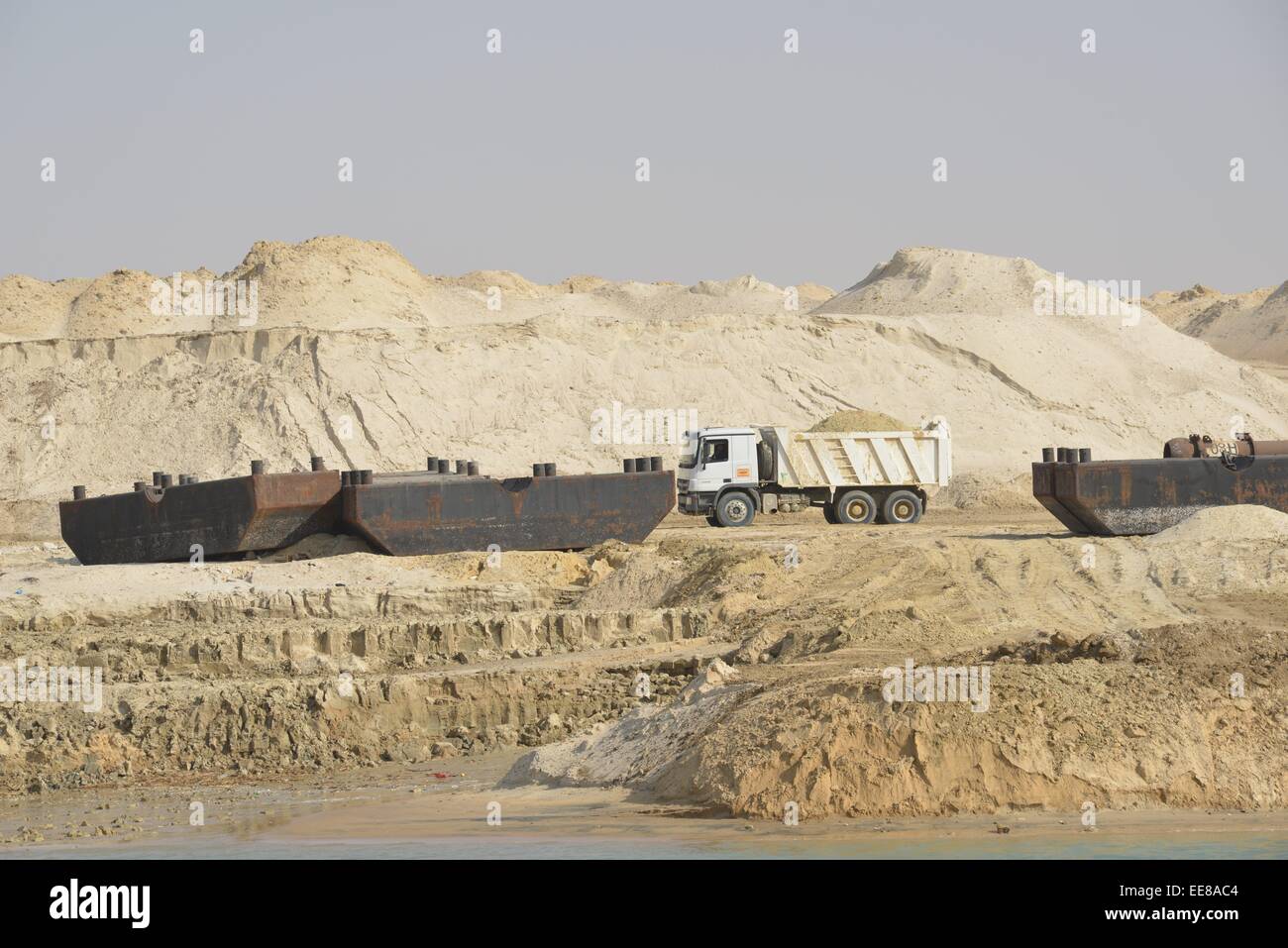 Earthmoving and dredging machines in action digging the new Suez Canal ...
