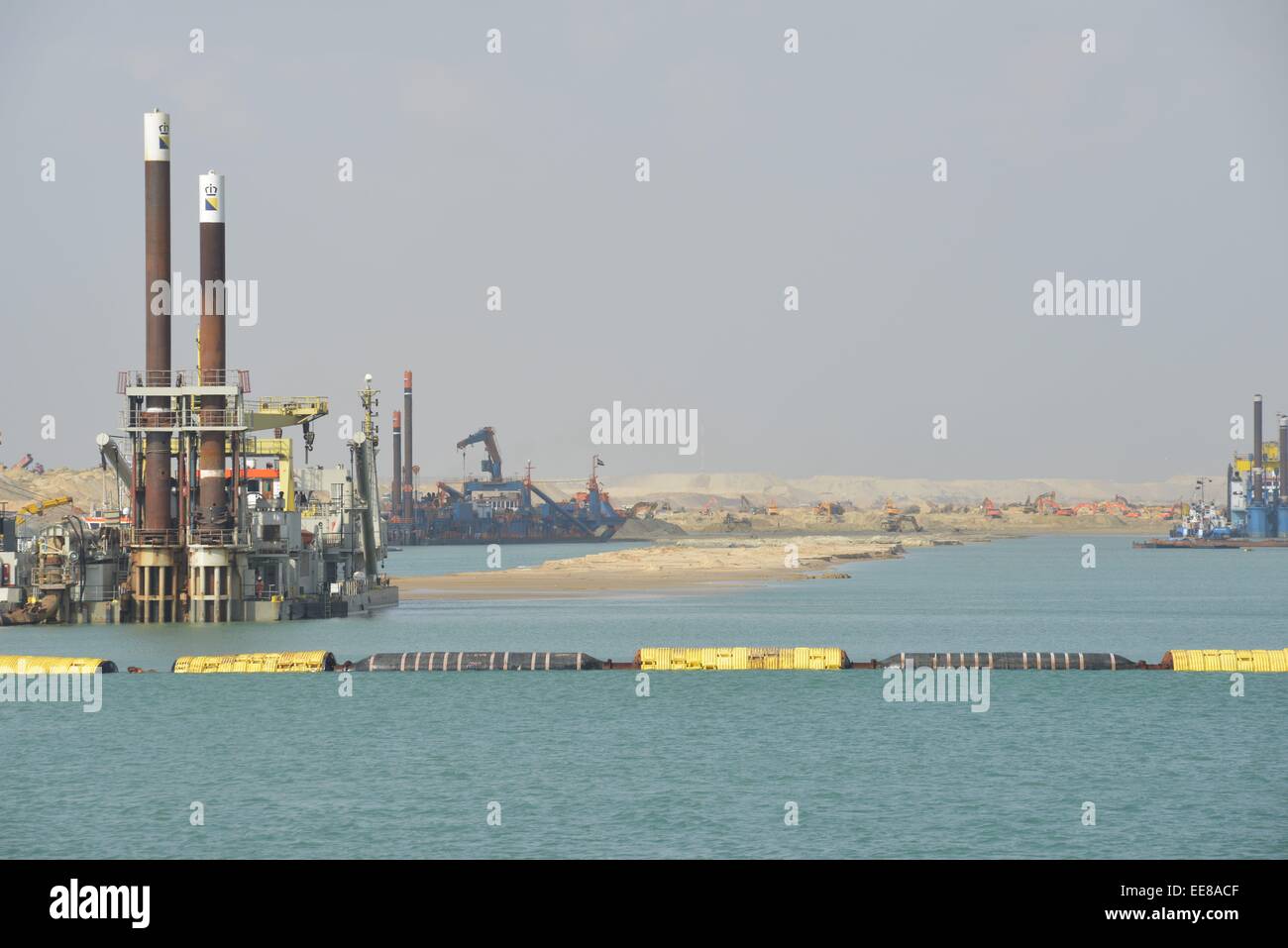 Earthmoving and dredging machines in action digging the new Suez Canal ...