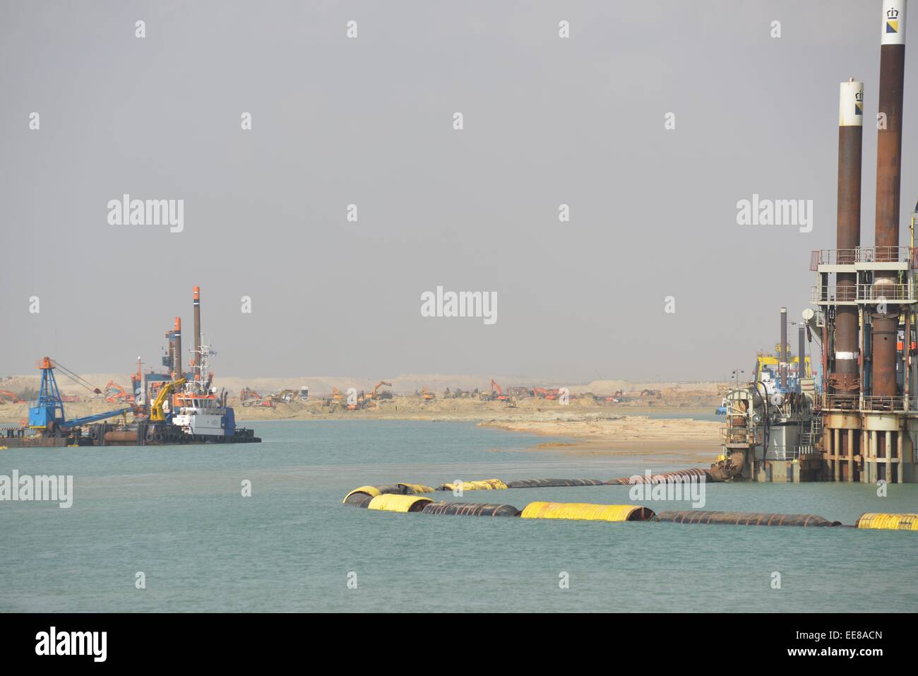 Earthmoving and dredging machines in action digging the new Suez Canal ...