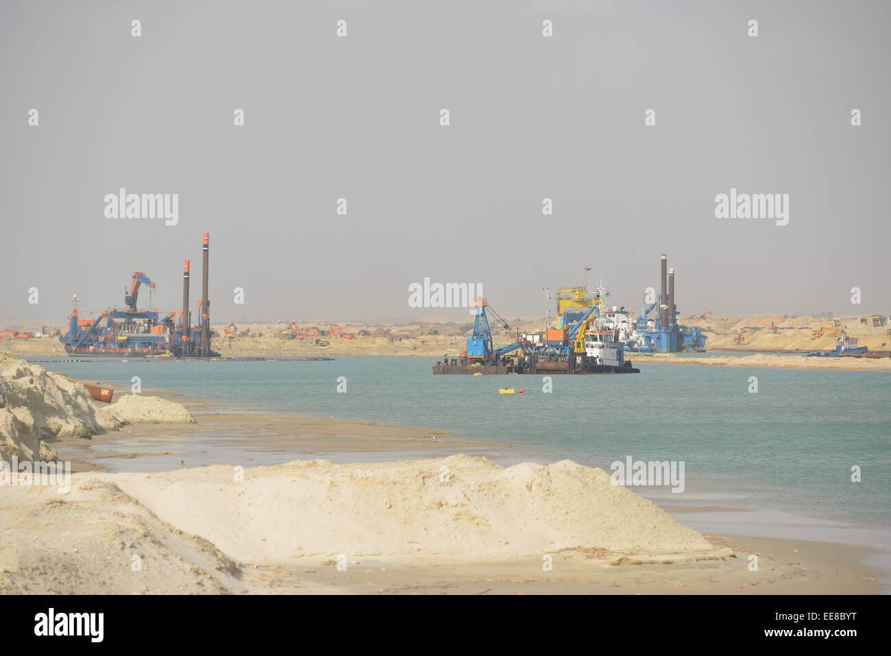 Earthmoving and dredging machines in action digging the new Suez Canal ...