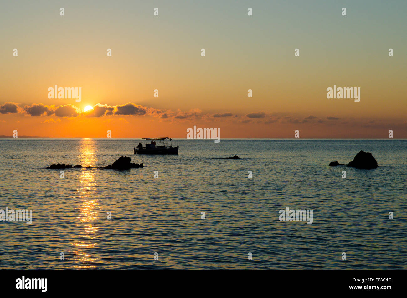 Fisherman in boat fishing in the bay at Velanio beach, near Staphylos ...