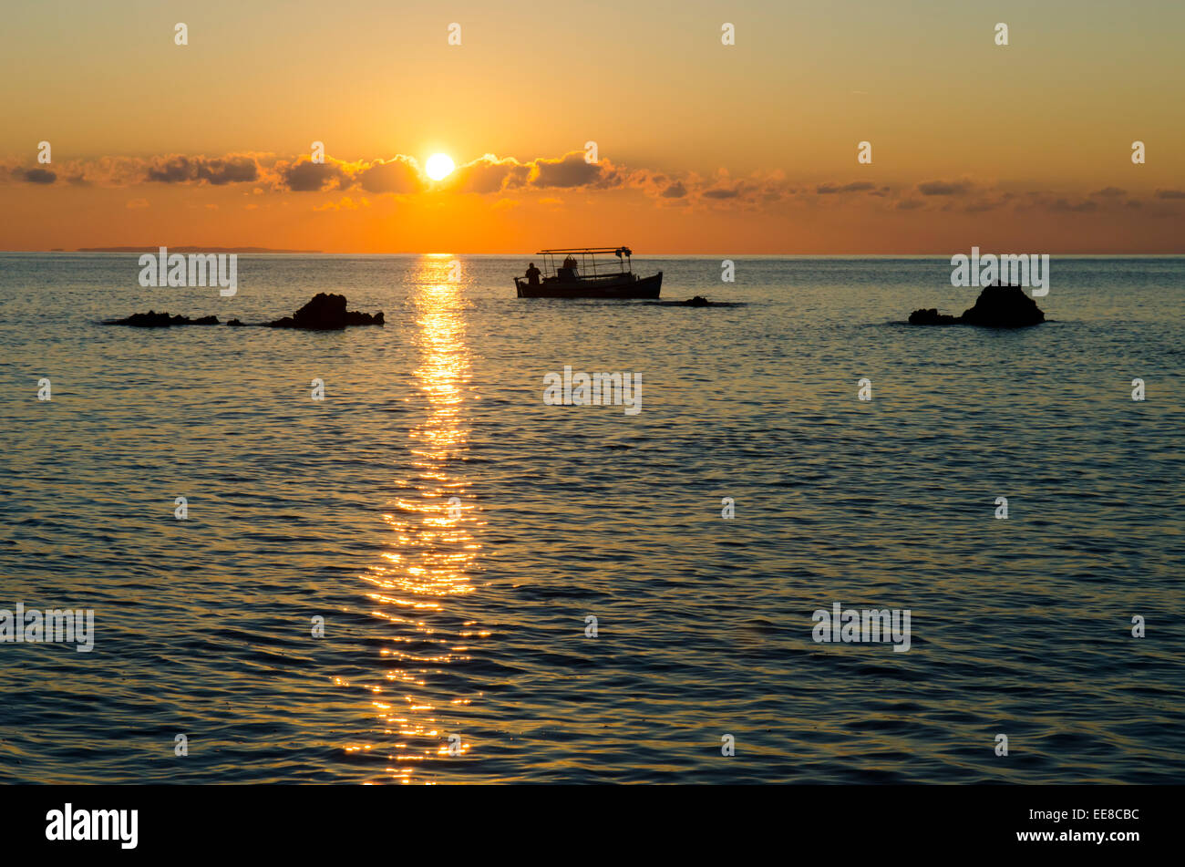 Fisherman in boat fishing in the bay at Velanio beach, near Staphylos ...