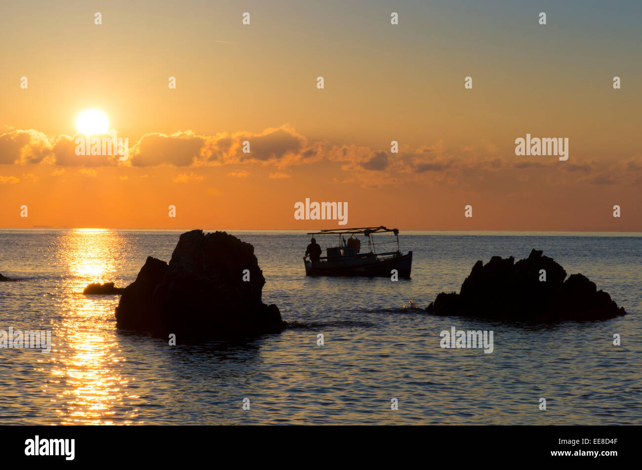 Fisherman in boat fishing in the bay at Velanio beach, near Staphylos ...