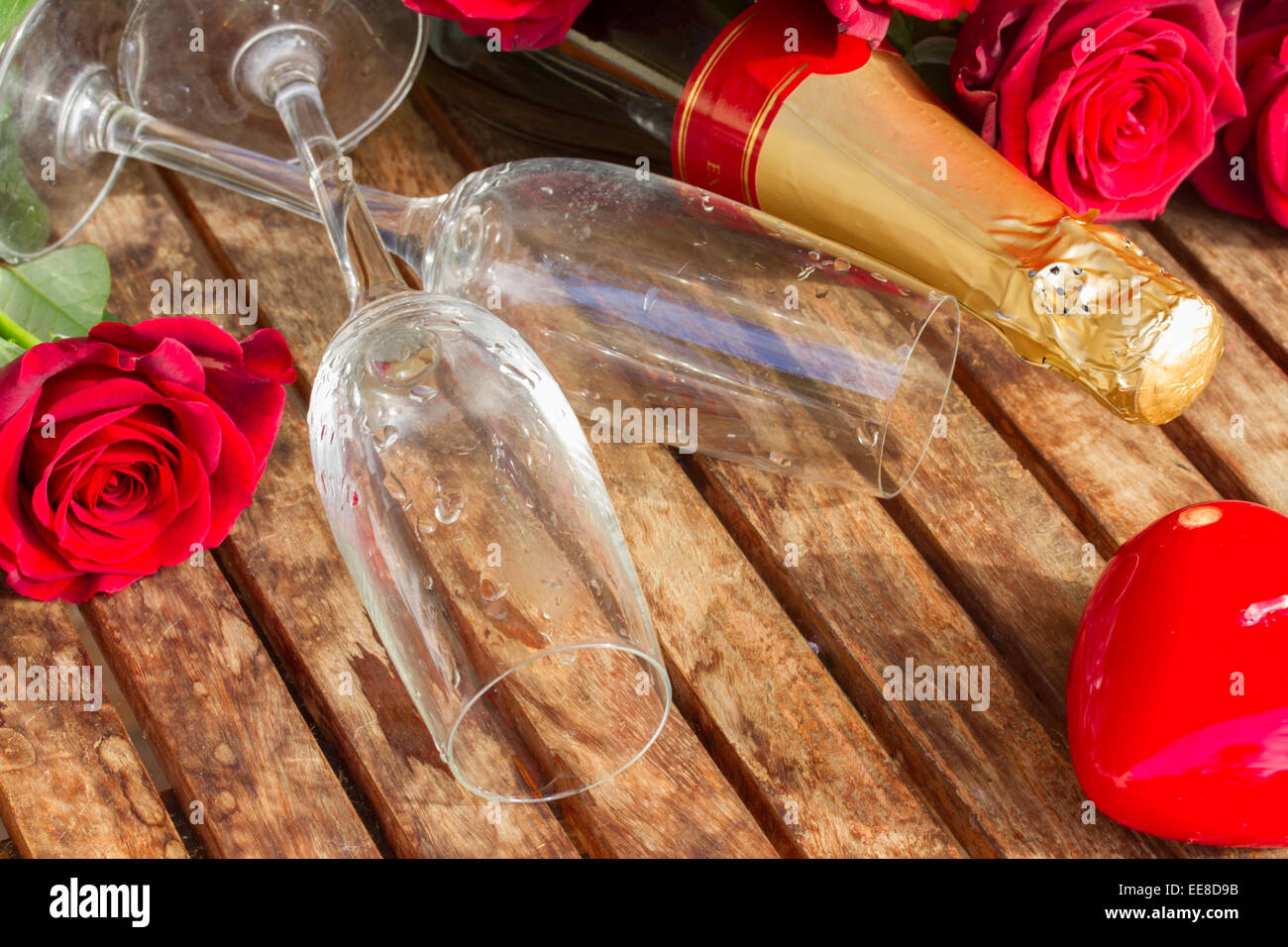 dark red roses with neck of champagne Stock Photo - Alamy