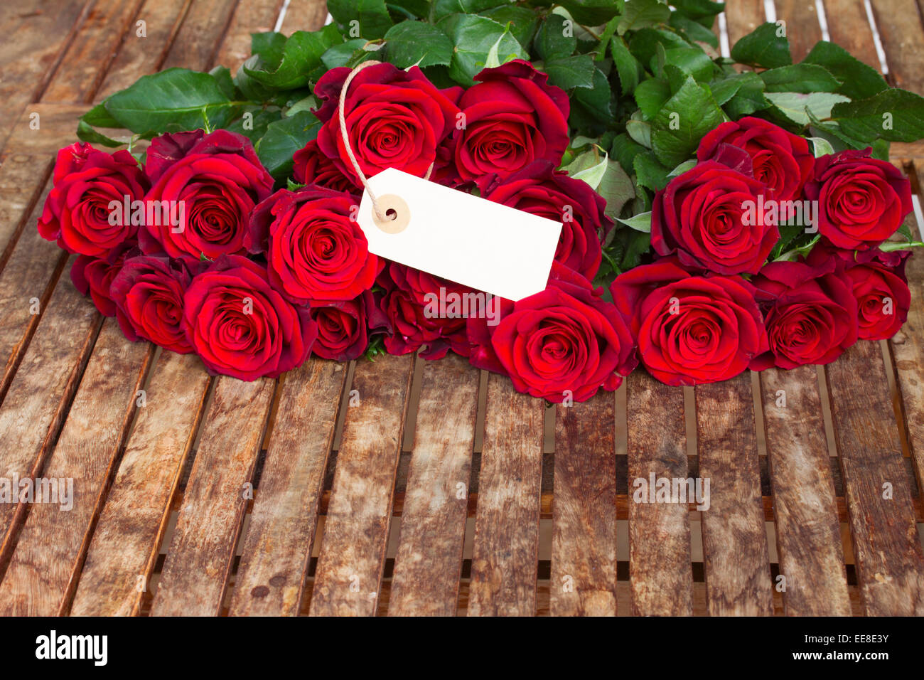 dark red roses and tag Stock Photo - Alamy