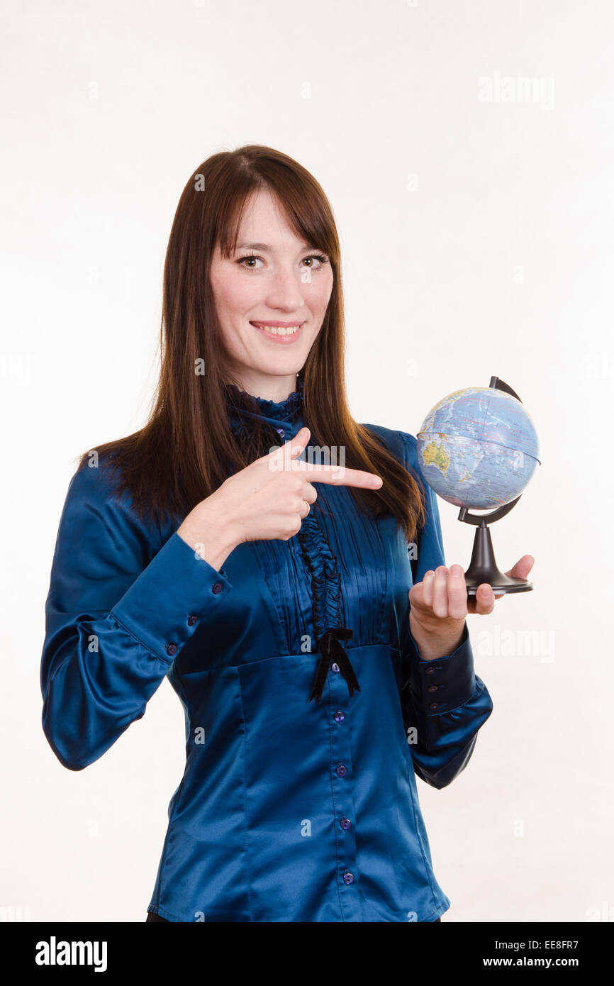 Portrait of a young beautiful girl in blue blouse on a white background ...