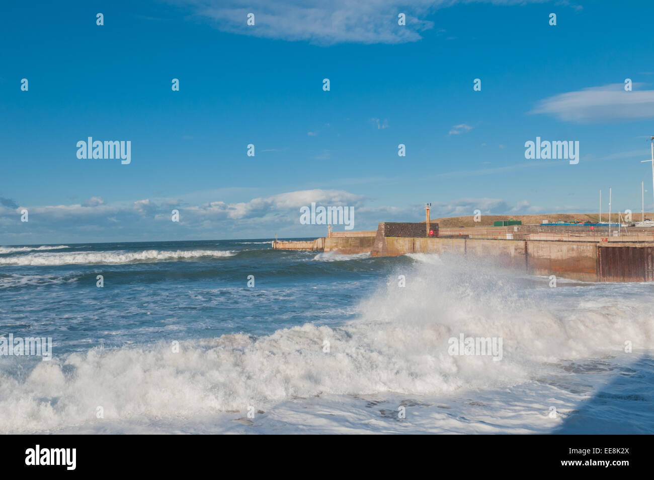 Waves crashing onto the shore Eyemouth Scottish Borders Scotland with ...