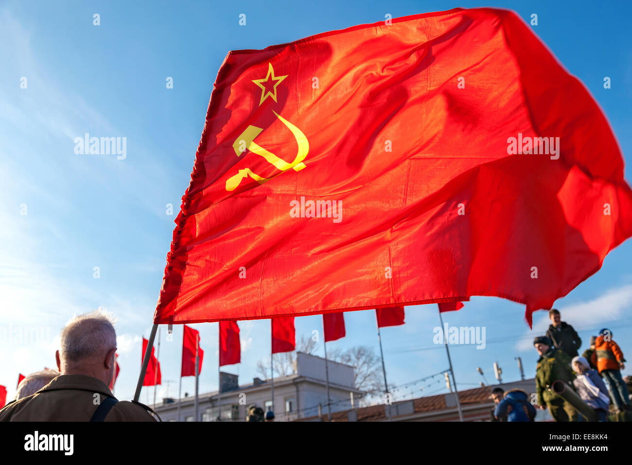 Red flag waving over blue sky background at the Kuibyshev square in ...