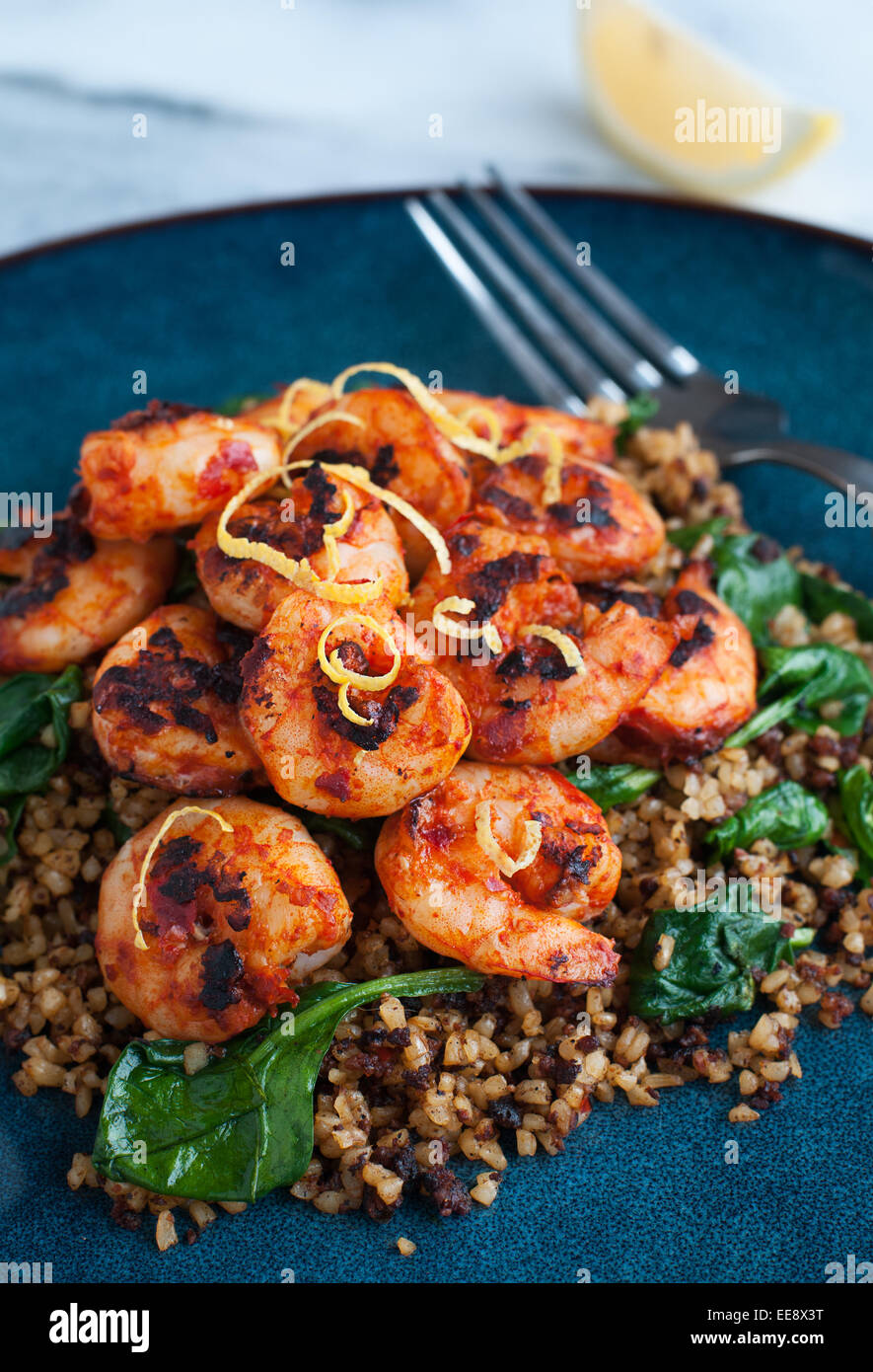Harissa shrimp over chorizo bulgur Stock Photo - Alamy