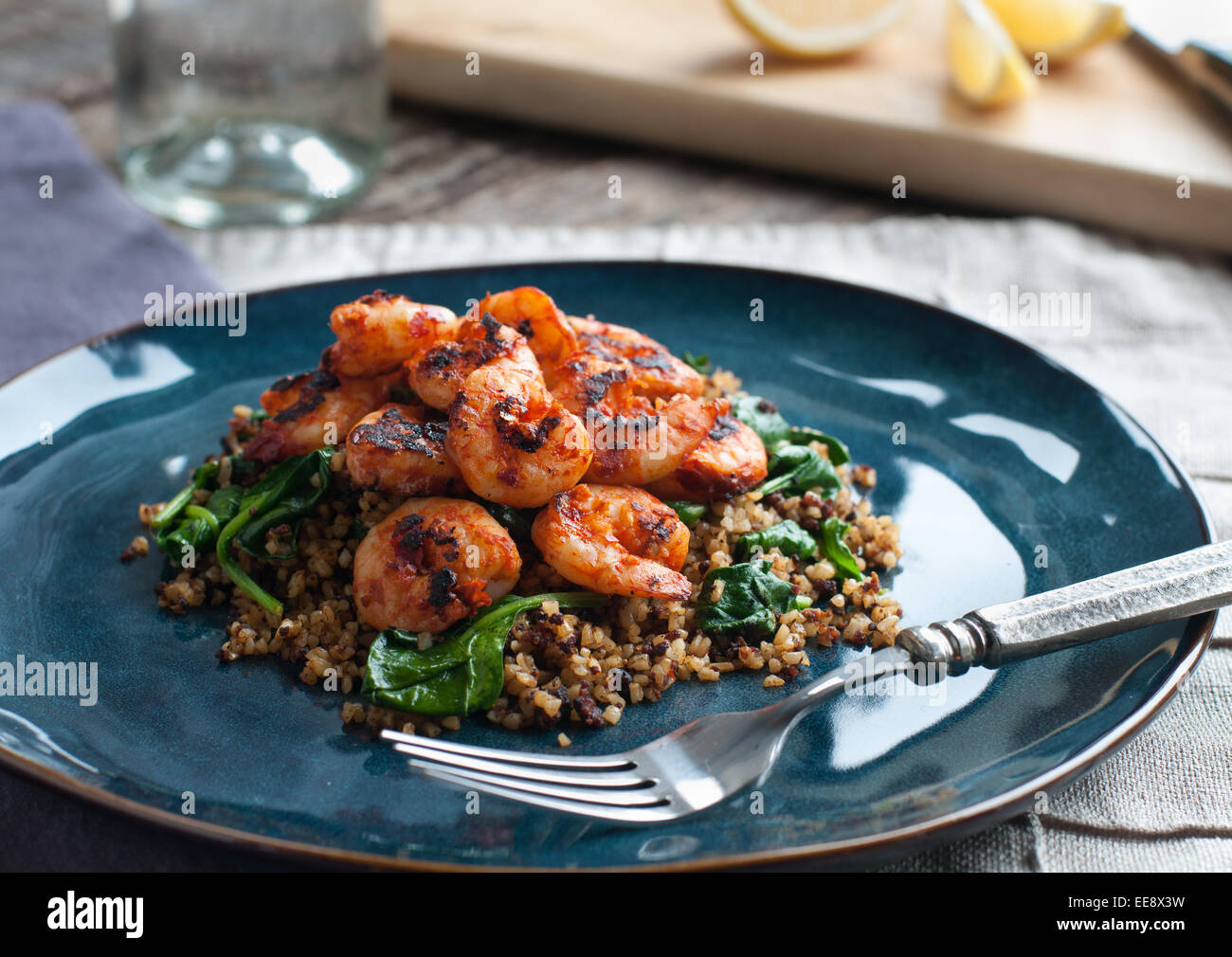 Harissa shrimp over chorizo bulgur Stock Photo - Alamy