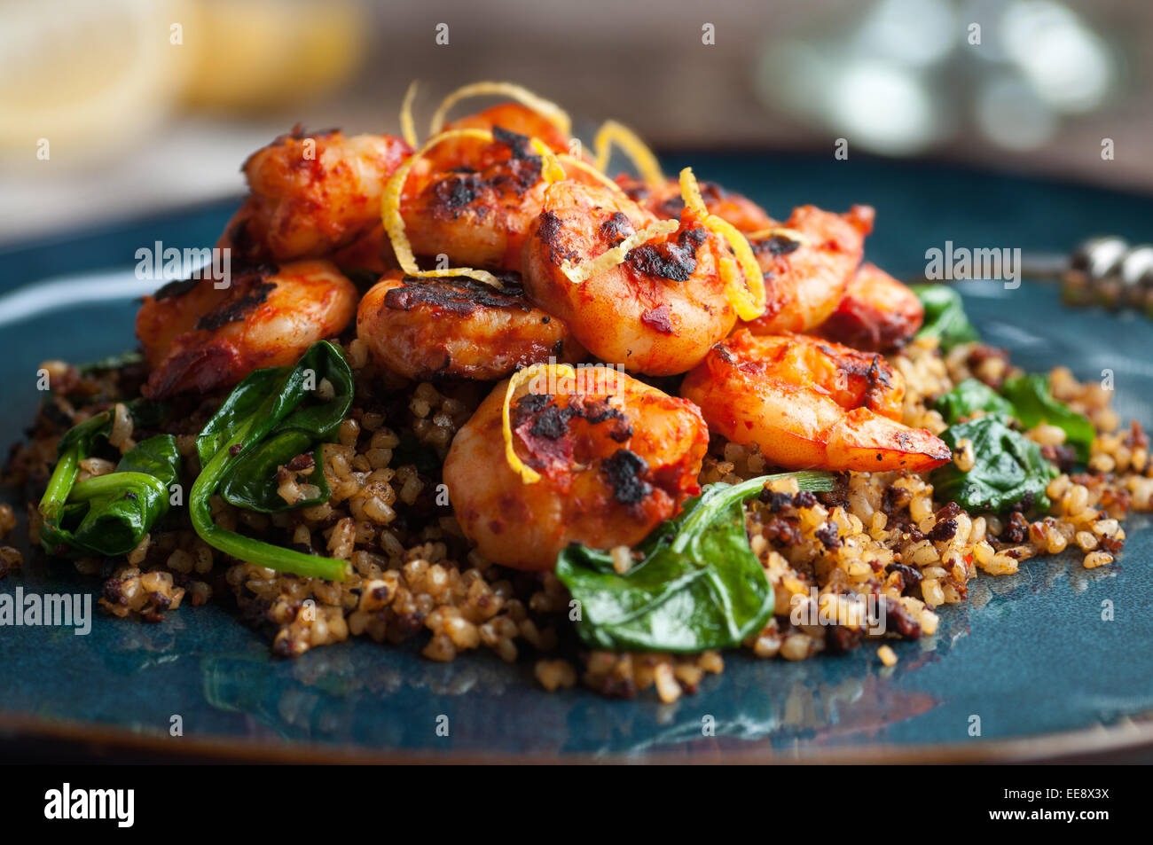 Harissa shrimp over chorizo bulgur Stock Photo - Alamy