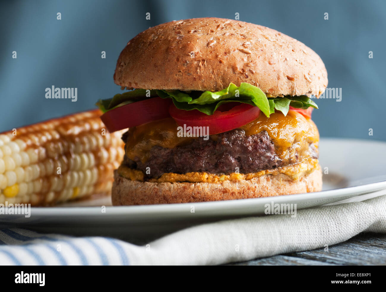 Cheeseburgers with corn on the cob with bbq sauce Stock Photo - Alamy