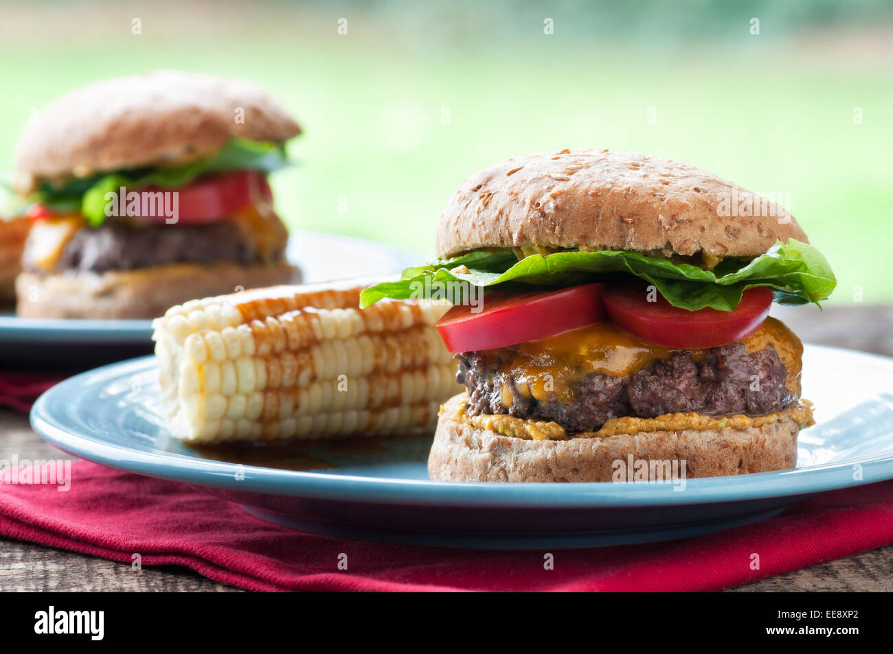 Cheeseburgers with corn on the cob with bbq sauce Stock Photo - Alamy