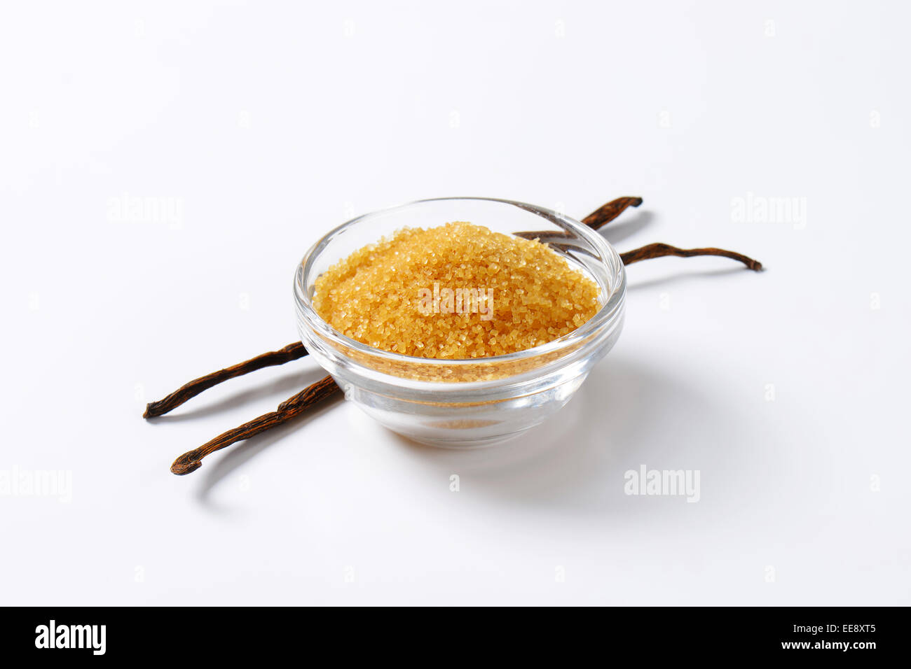 Bowl of golden brown raw cane sugar and two vanilla pods Stock Photo ...