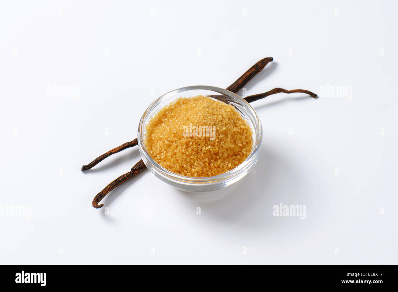 Bowl of golden brown raw cane sugar and two vanilla pods Stock Photo ...